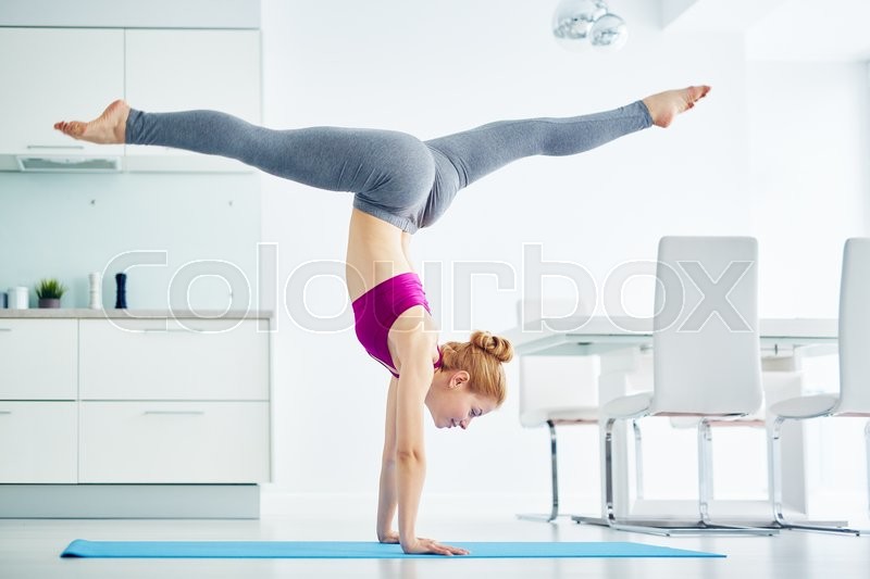 Young woman balancing on hands | Stock image | Colourbox