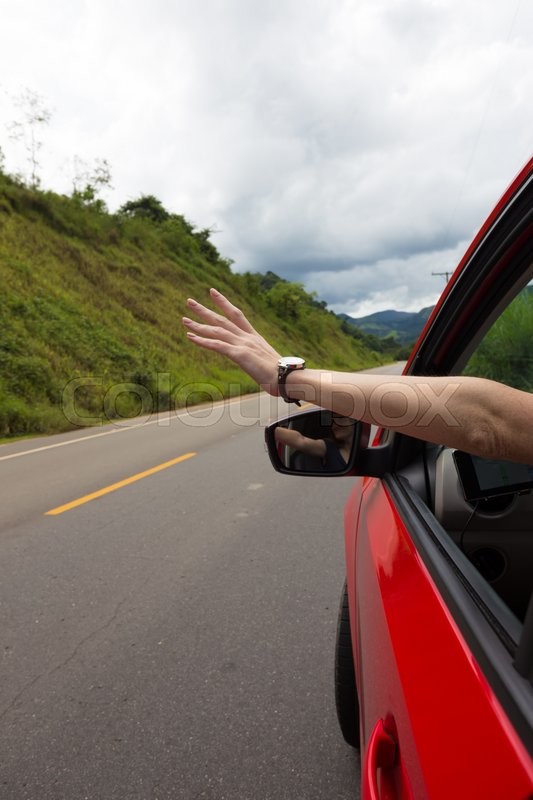 Girl hand at the car window on an empty ... | Stock image | Colourbox