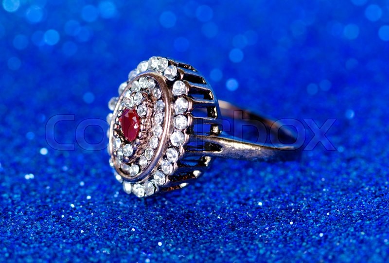 Jewellery ring against blue background | Stock image | Colourbox