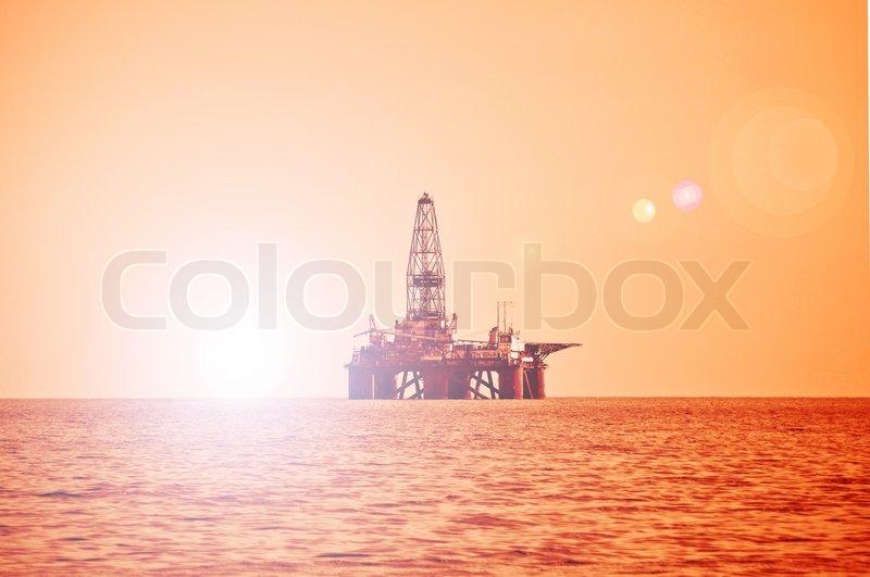 Offshore oil rig during sunset in ... | Stock image | Colourbox