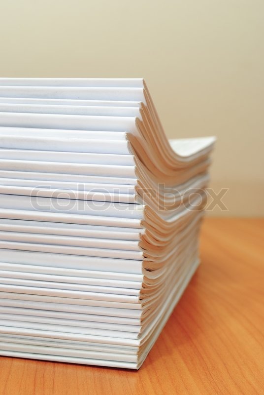 Stack of white journals in office ... | Stock image | Colourbox