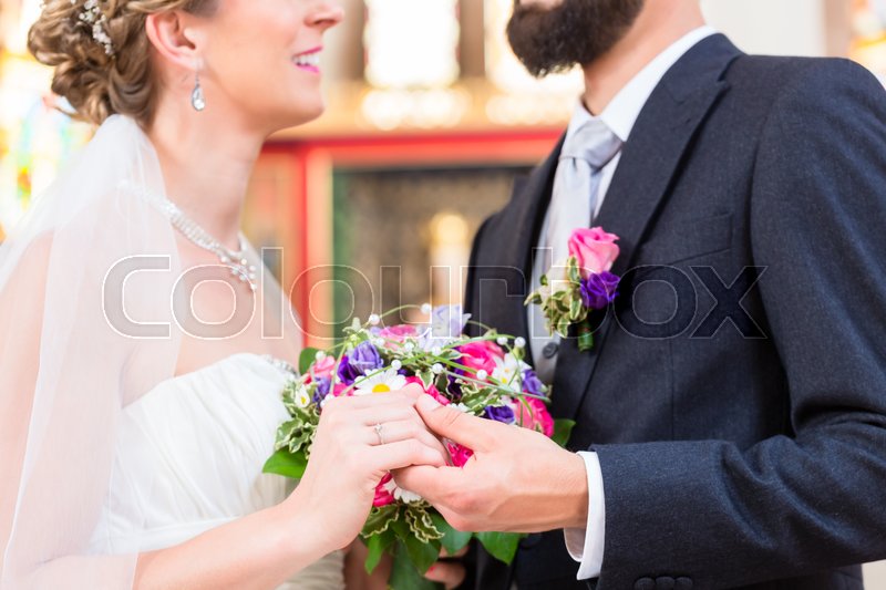 Bridal couple in church having wedding | Stock image | Colourbox