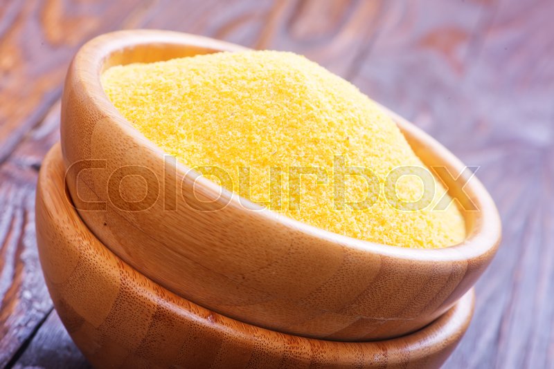 Corn porridge in bowl and on a table | Stock Photo | Colourbox