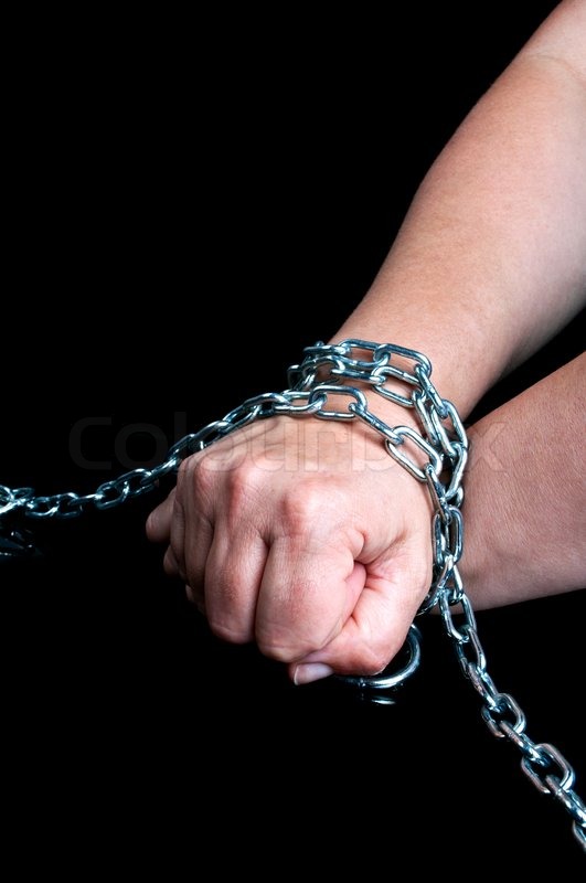 Hands in chain on a black background | Stock image | Colourbox