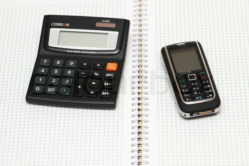 Mobile phone, calculator and pen on ... | Stock image | Colourbox