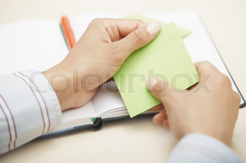 Hands holding sticky note with empty ... | Stock image | Colourbox