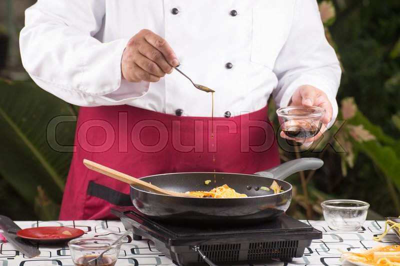 Chef putting soy sauce for cooking / ... | Stock image | Colourbox