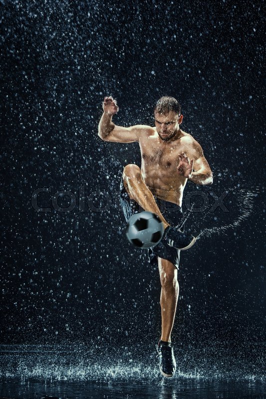 Water drops around football player ... | Stock image | Colourbox