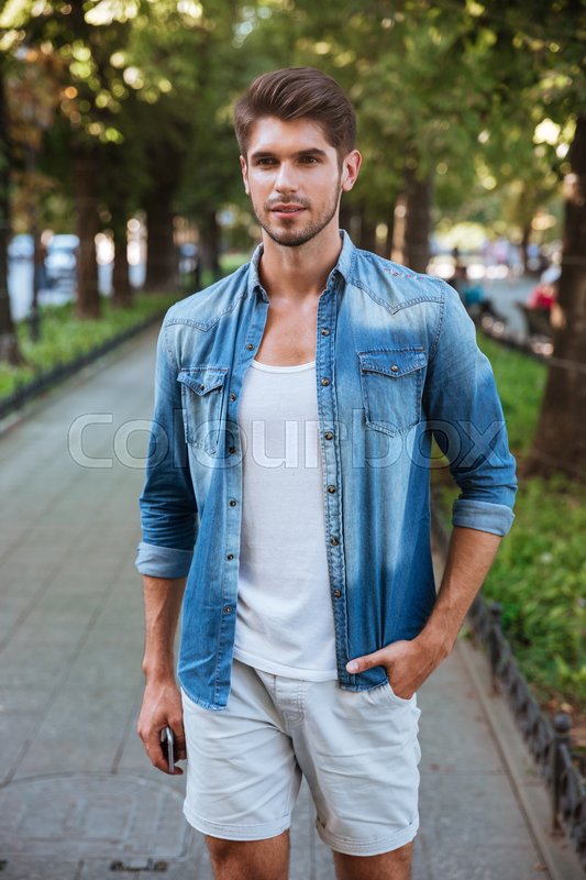 Handsome young man standing on the ... | Stock image | Colourbox