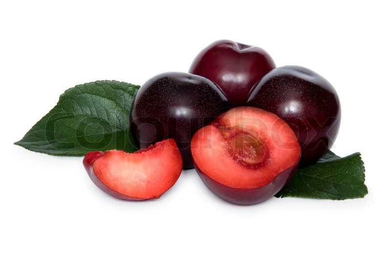 Some plums with two slices of plum over ... | Stock image | Colourbox