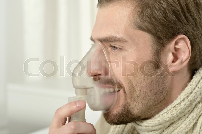 Portrait Of Man Inhaling Through ... | Stock image | Colourbox