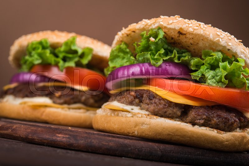 Home made tasty burgers on wooden table | Stock image | Colourbox