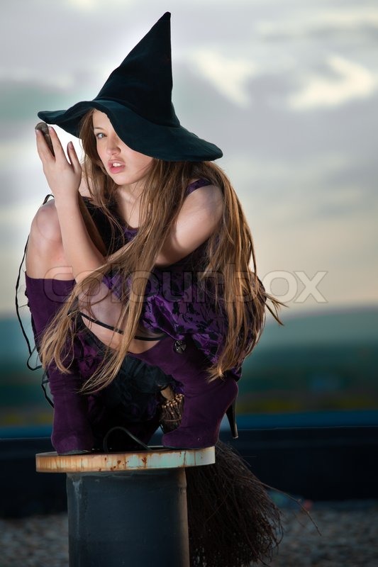 Hübsche Hexe mit Hut und Besen , im Freien | Stockfoto | Colourbox