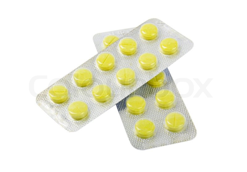 Pakke med gule tabletter på den hvide | Stock foto | Colourbox