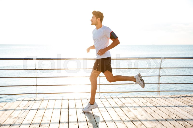 Handsome young man athlete running ... | Stock image | Colourbox