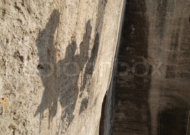 Human shadows on the bright yellow rock | Stock Photo | Colourbox