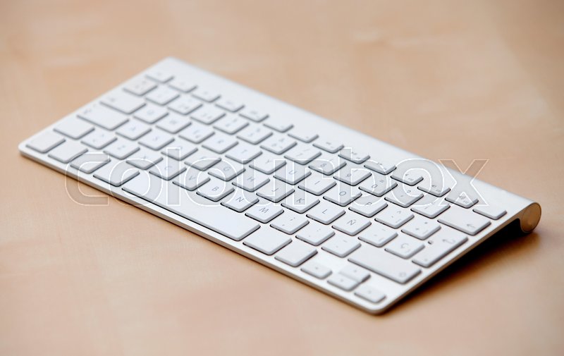 Silver computer keyboard over wooden ... | Stock image | Colourbox