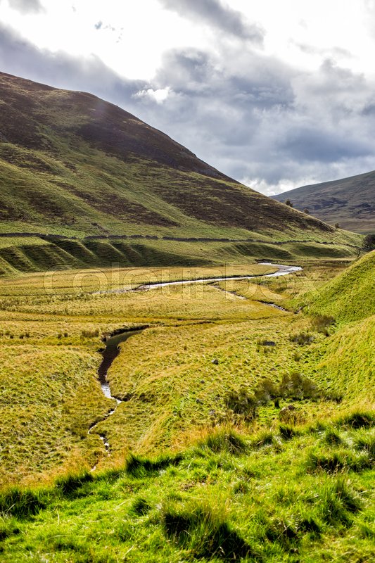 Landscape with hills and river in ... | Stock image | Colourbox