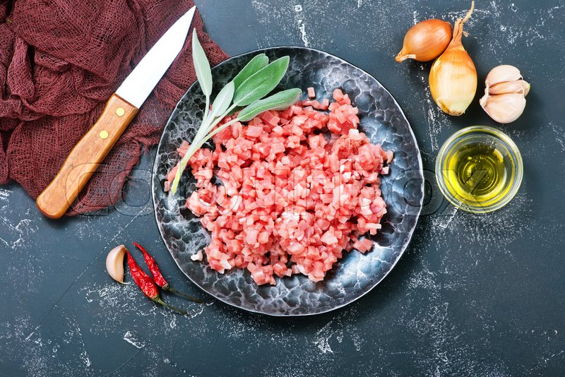 Minced meat on plate and on a table | Stock image | Colourbox