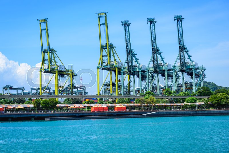 Cargo cranes in jetty by the water over ... | Stock image | Colourbox