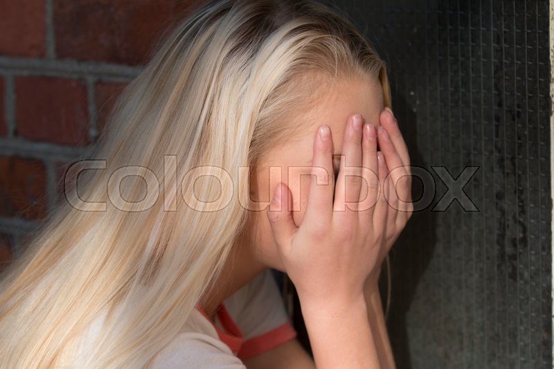 Sad girl left alone | Stock image | Colourbox