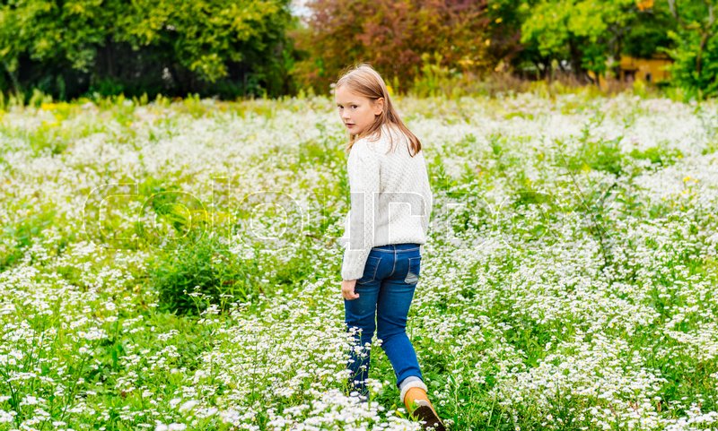 Cute little girl playing in a field, ... | Stock image | Colourbox