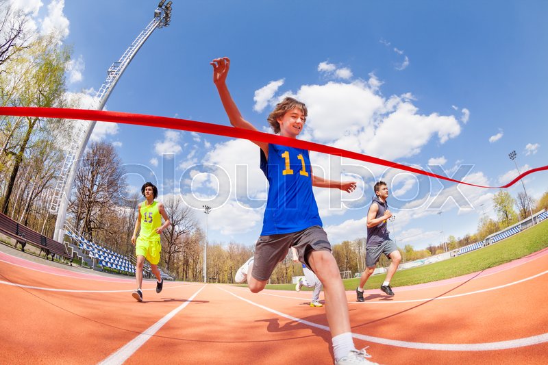 Happy teenage sprinter winning race and ... | Stock image | Colourbox
