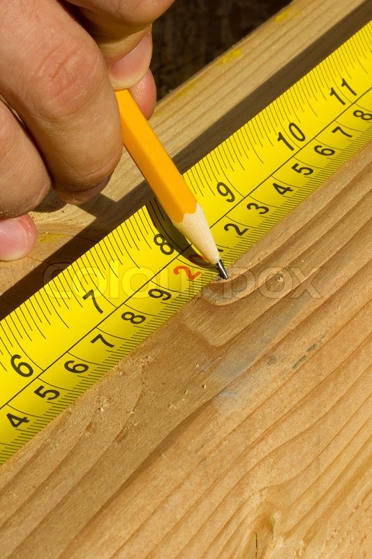 Closeup view of a worker measuring a ... | Stock image | Colourbox