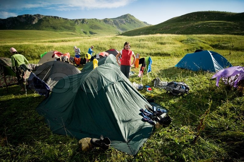 Group of people camping near mountains | Stock Photo | Colourbox
