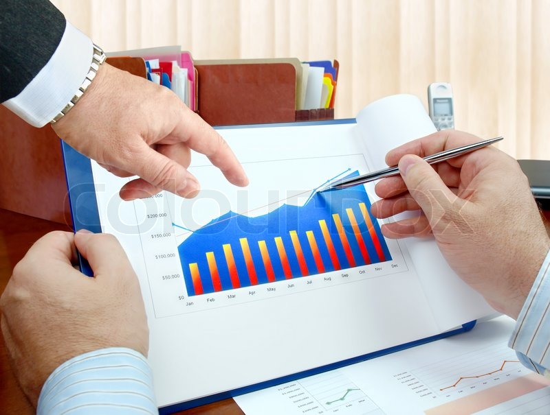 Closeup of hands with financial charts ... | Stock image | Colourbox