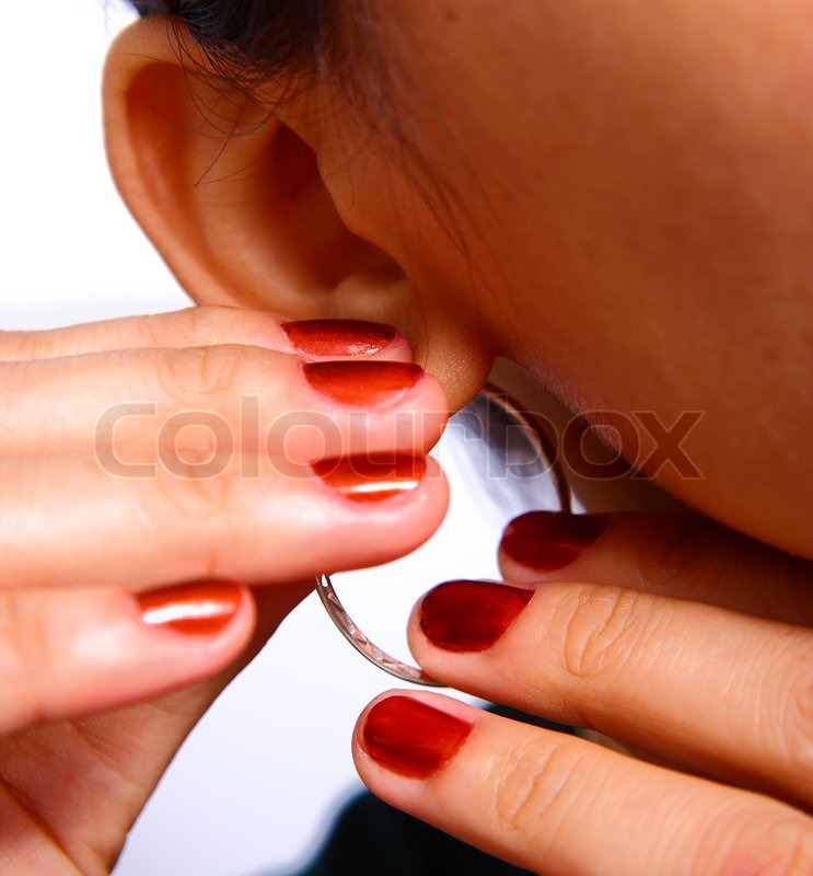Putting A Pair Of Earrings On Ready To ... | Stock image | Colourbox