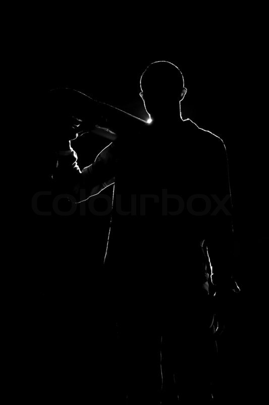 A backlit skateboarder guy posing under ... | Stock image | Colourbox
