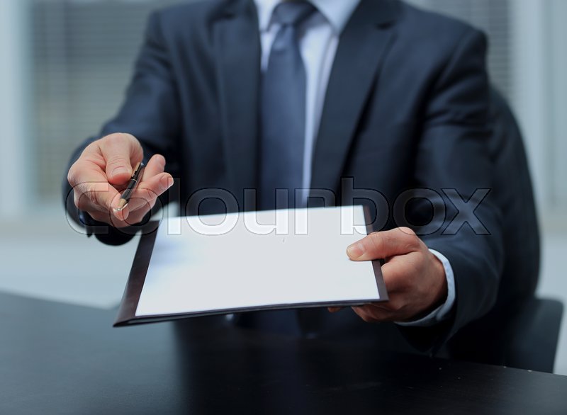 Businessman giving pen for your ... | Stock image | Colourbox