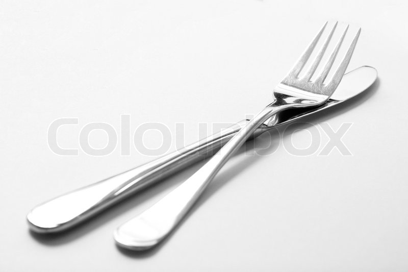 A fork and a knife crossing each other ... | Stock image | Colourbox