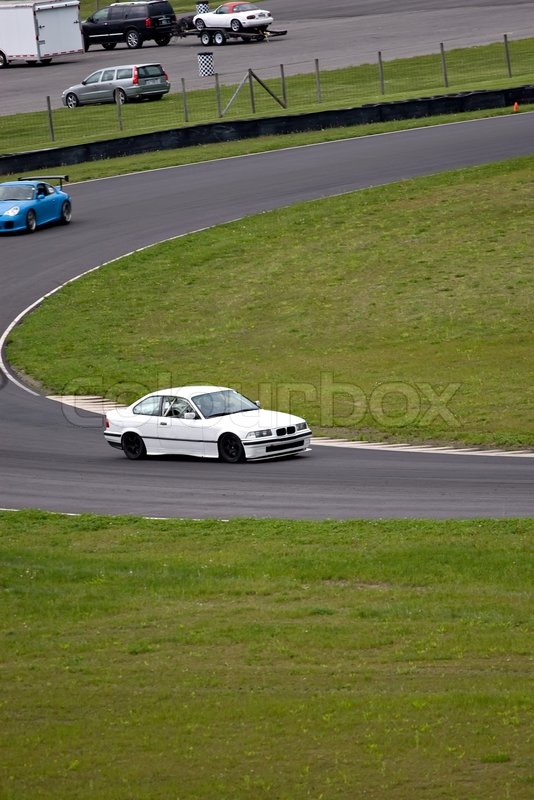 Sports car racing around a road course ... | Stock image | Colourbox