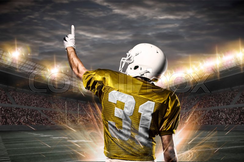 Football Player on a yellow uniform ... | Stock image | Colourbox