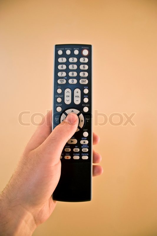A hand holding a remote control ... | Stock image | Colourbox