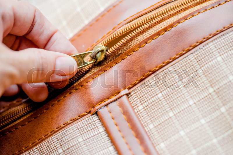 Hands unlocked zipper a bag. | Stock image | Colourbox