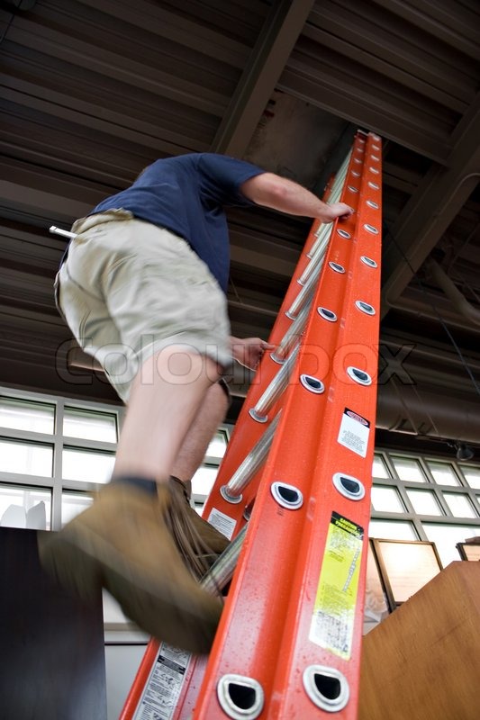A young worker climbing up a ladder to ... | Stock image | Colourbox