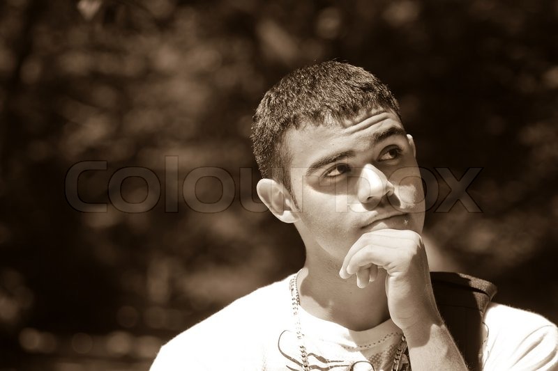 A young man that looks to be in deep ... | Stock image | Colourbox