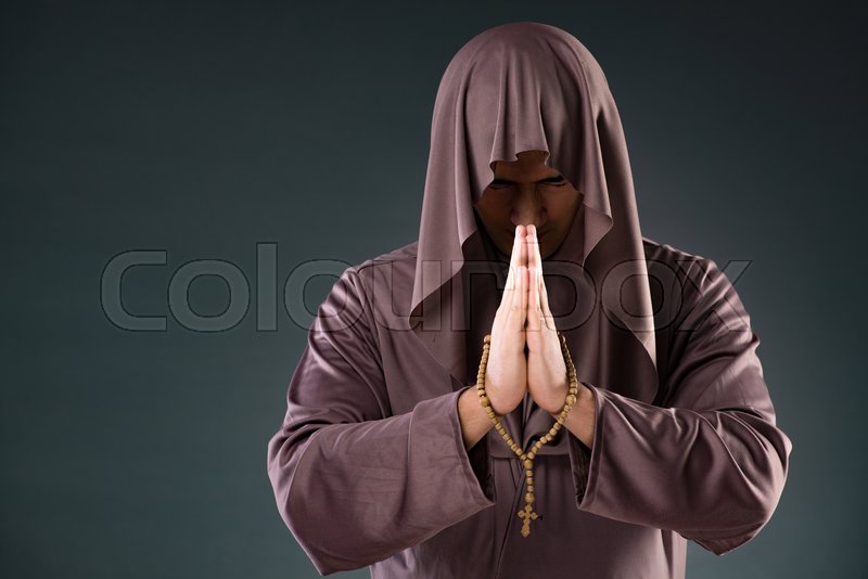 Monk in religious concept on gray ... | Stock image | Colourbox