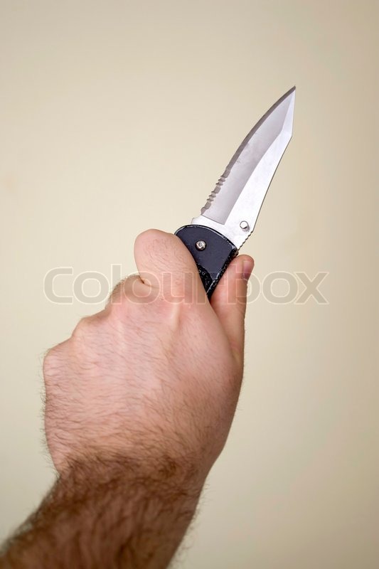 Closeup of a hand wielding a knife with ... | Stock image | Colourbox