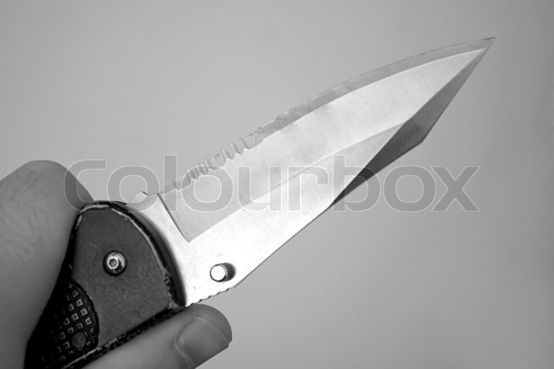 Closeup of a hand holding a knife with ... | Stock image | Colourbox
