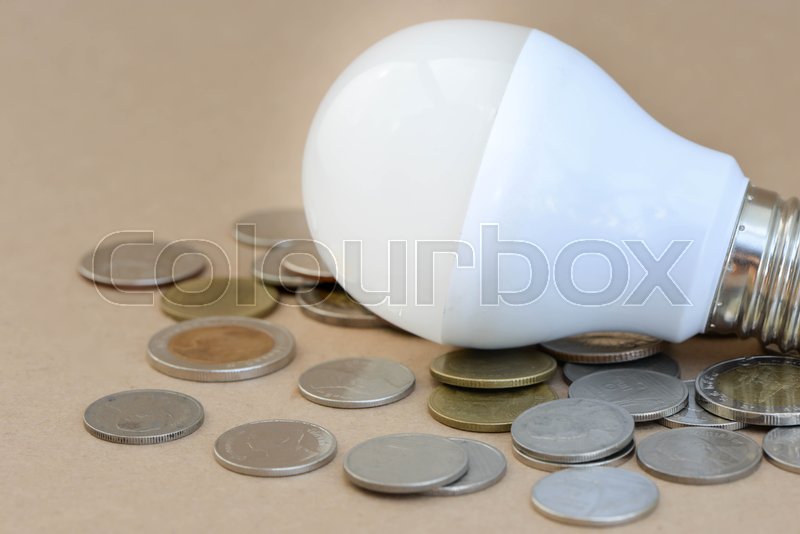 Concept of LED bulb with coins - the ... | Stock Photo | Colourbox