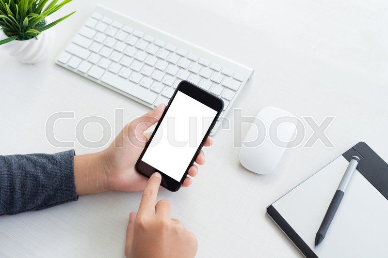 Hand hold phone mobile and touching on ... | Stock image | Colourbox