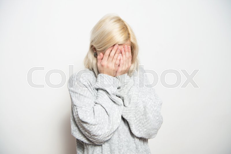 Woman covers his face by hand | Stock image | Colourbox