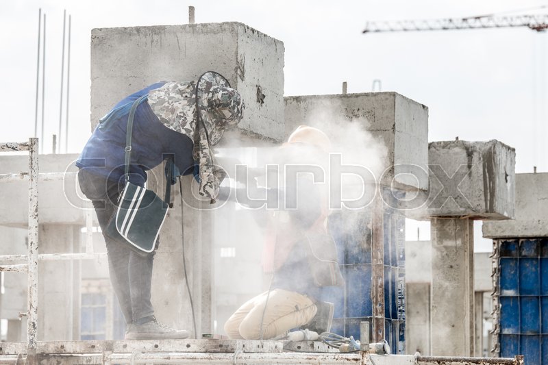 Construction workers grinding in ... | Stock image | Colourbox