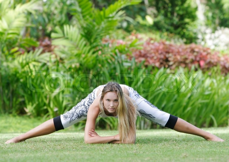 Young attractive woman doing yoga on ... | Stock Photo | Colourbox