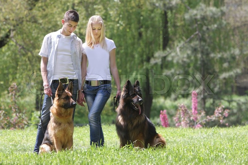 Young couple with two dogs on natural ... | Stock image | Colourbox