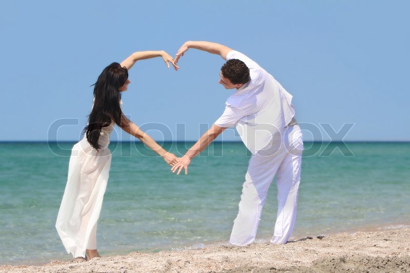 Young couple making heart by arms on ... | Stock image | Colourbox